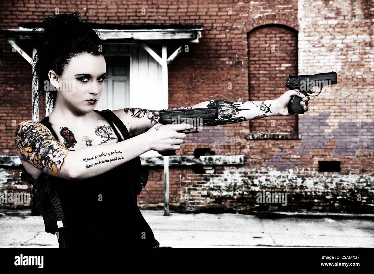 Beautiful young woman shooting things with pistols Stock Photo - Alamy