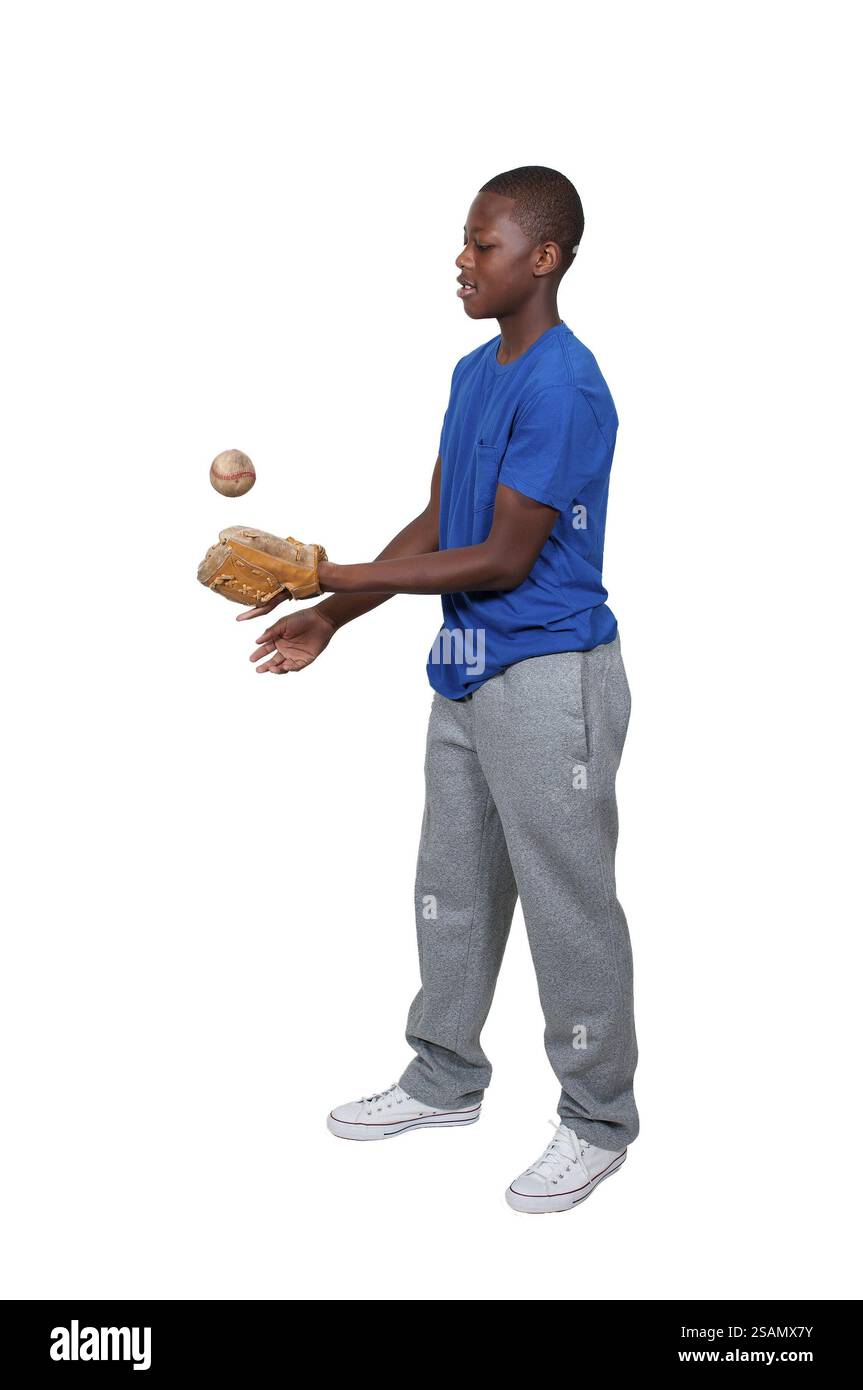 A black African American teenage man baseball pitcher getting ready to ...