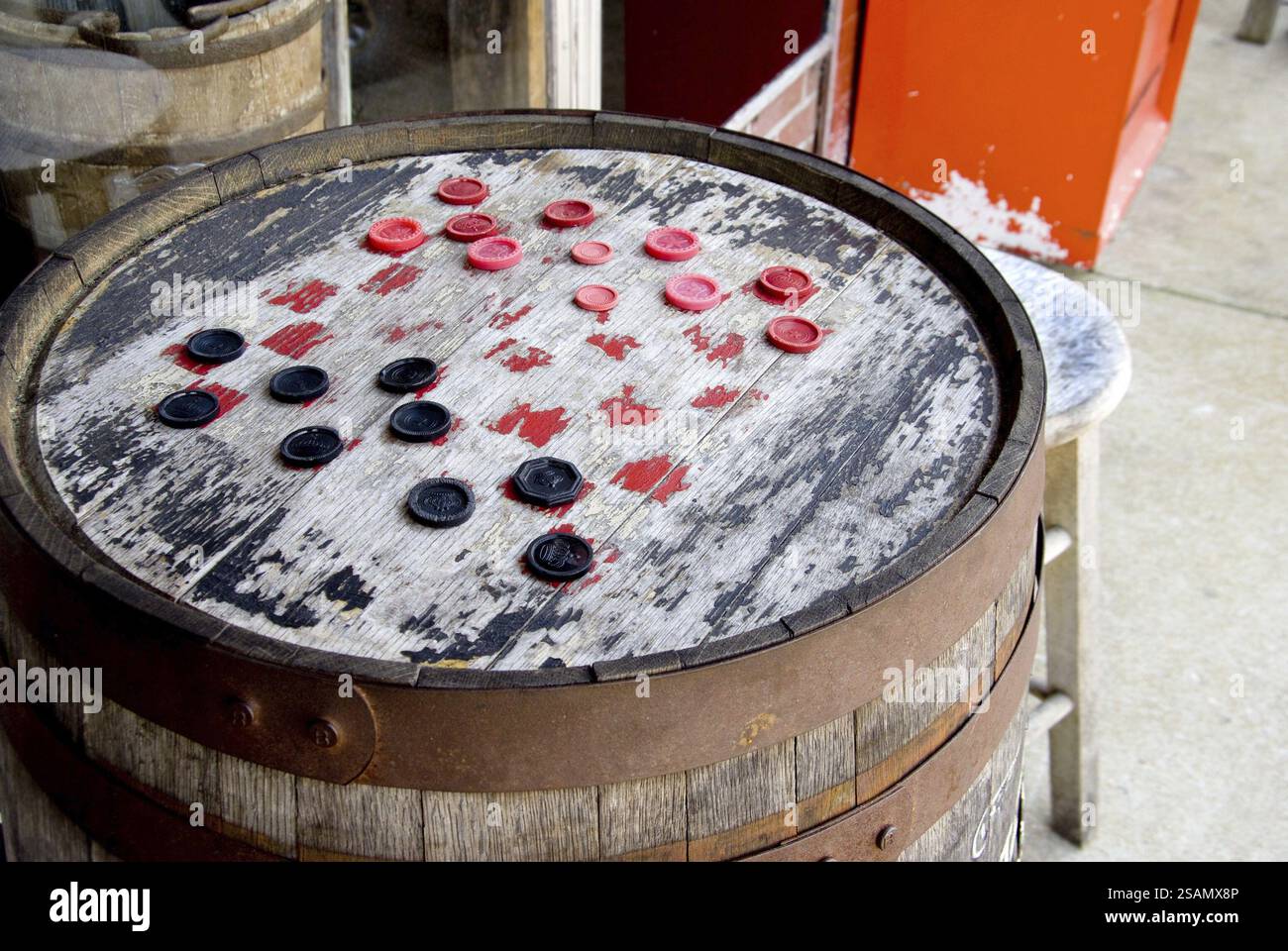 Checkers on a board made from an old barrel Stock Photo - Alamy