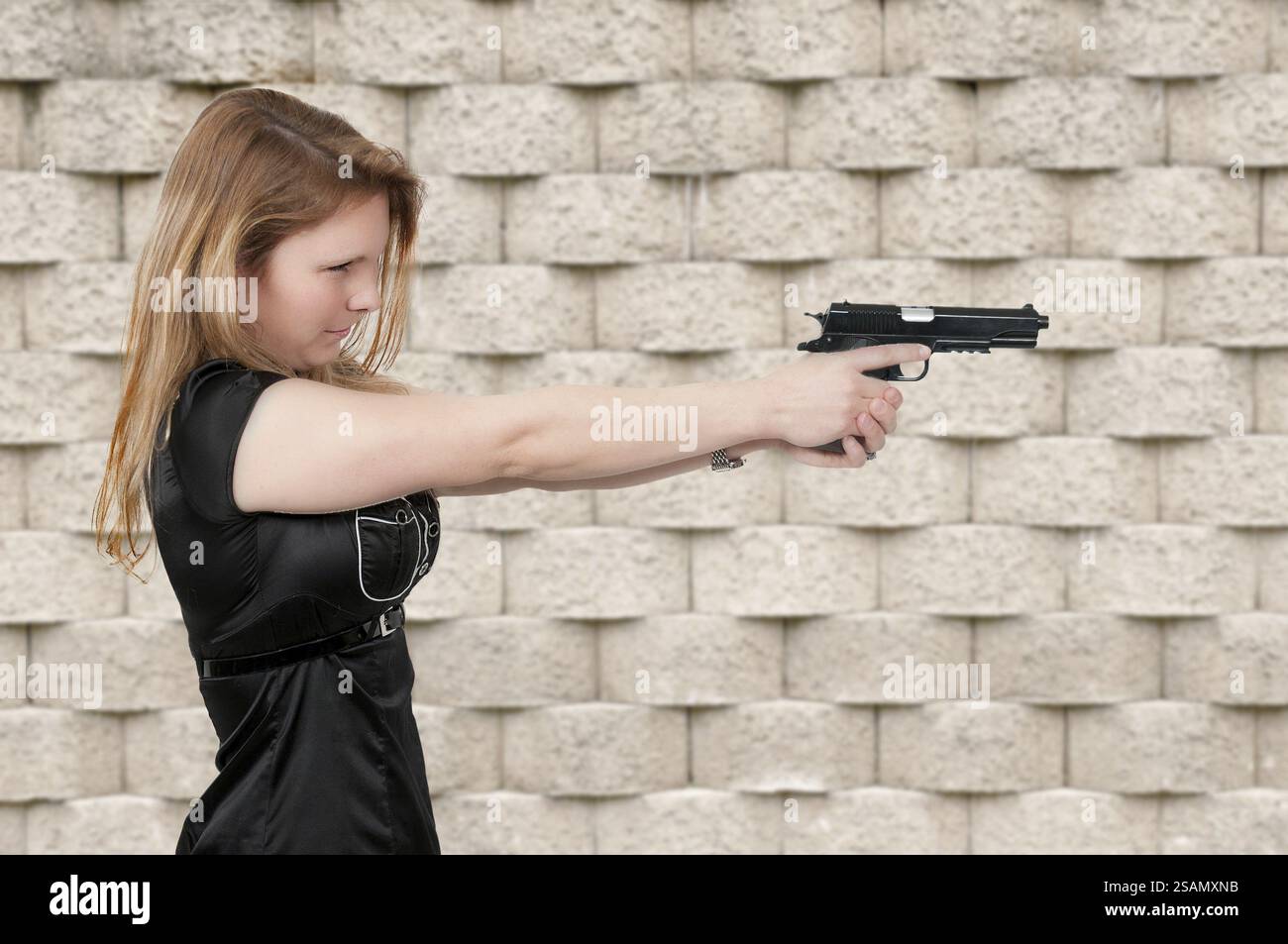 Beautiful woman with a loaded handgun pistol Stock Photo - Alamy