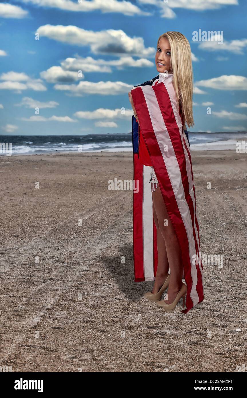 Beautiful young woman wrapped in a flag Stock Photo - Alamy