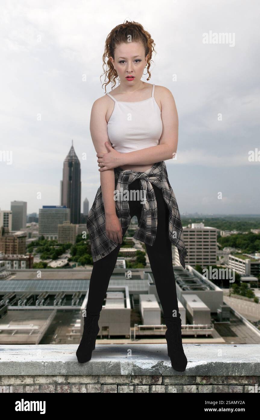Woman hipster girl modeling a pose on a wall Stock Photo - Alamy