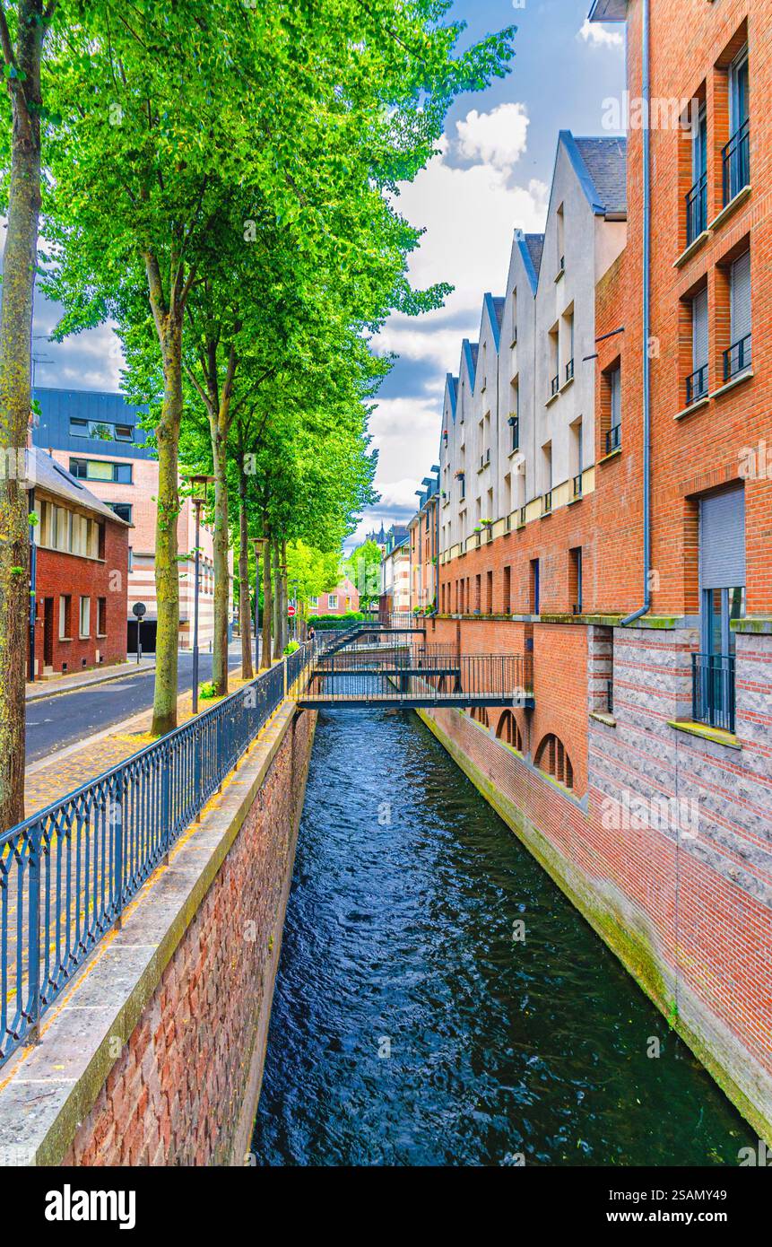 Brick buildings with small bridges over narrow water canal and street ...