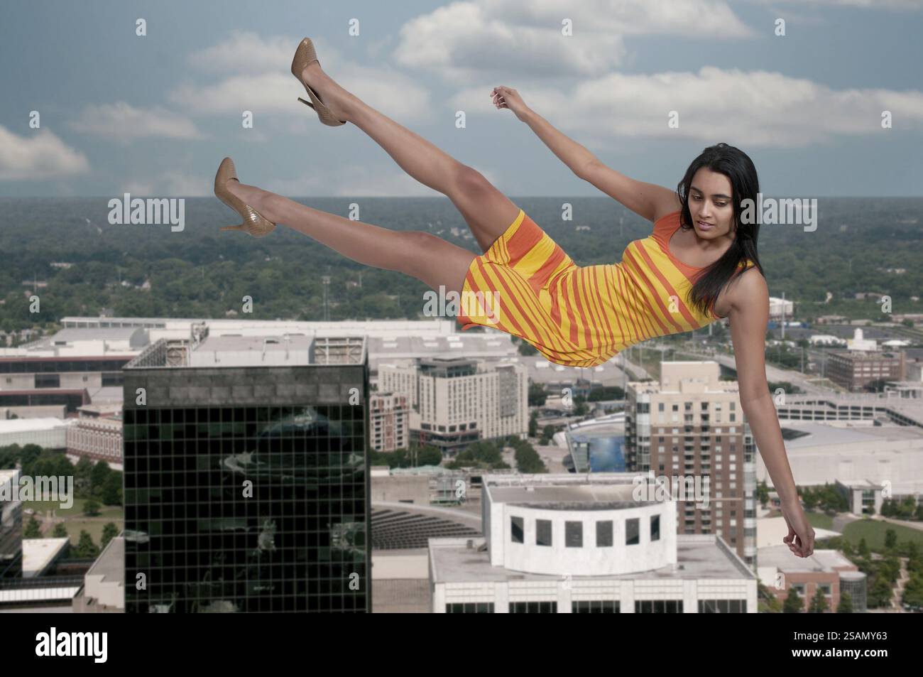 Beautiful young woman falling through the sky Stock Photo - Alamy