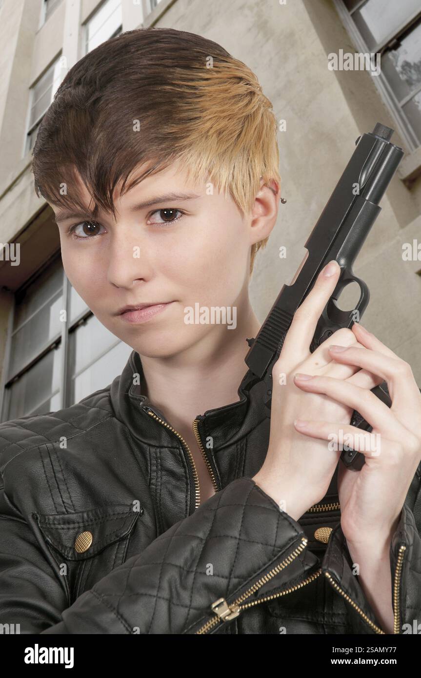 Beautiful woman with a loaded handgun pistol Stock Photo - Alamy