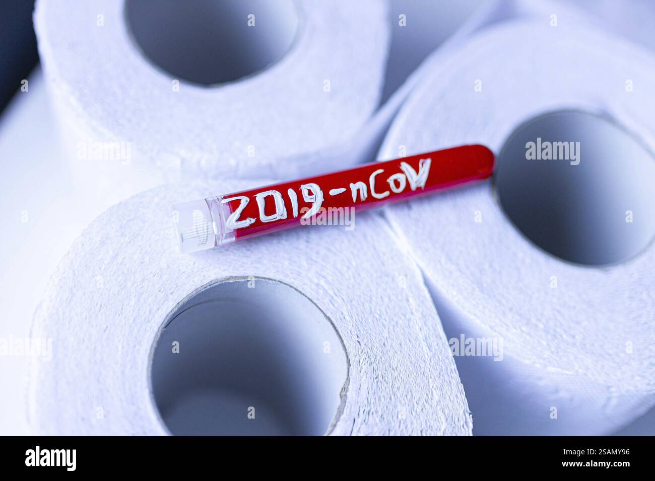 Red test tube labeled 2019-nCoV on stacked toilet paper rolls Stock ...