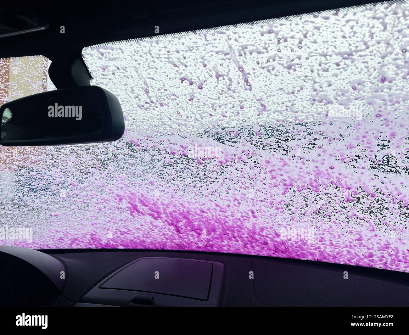 Foam-covered windshield of a car viewed from the interior during a ...