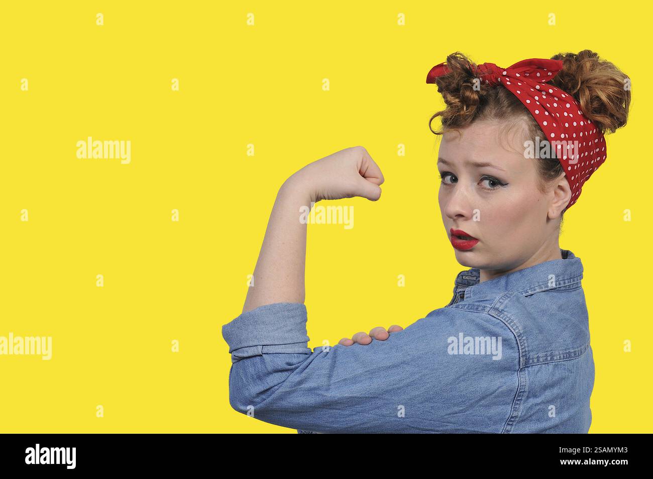 Beautiful woman dressed as the iconic Rosie the Riveter Stock Photo - Alamy