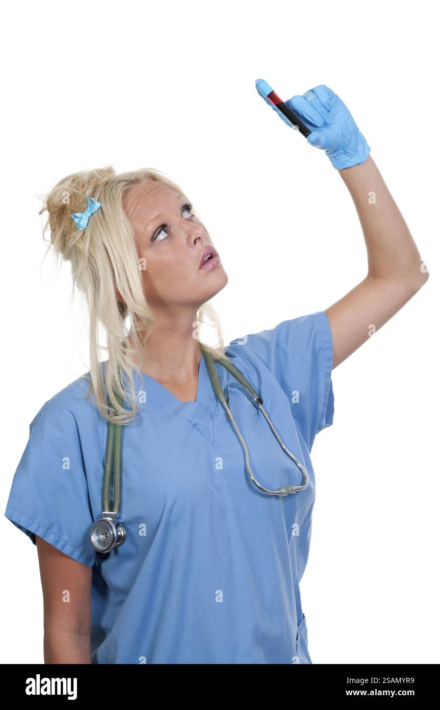 A beautiful young female doctor holding a test tube vial sample of ...