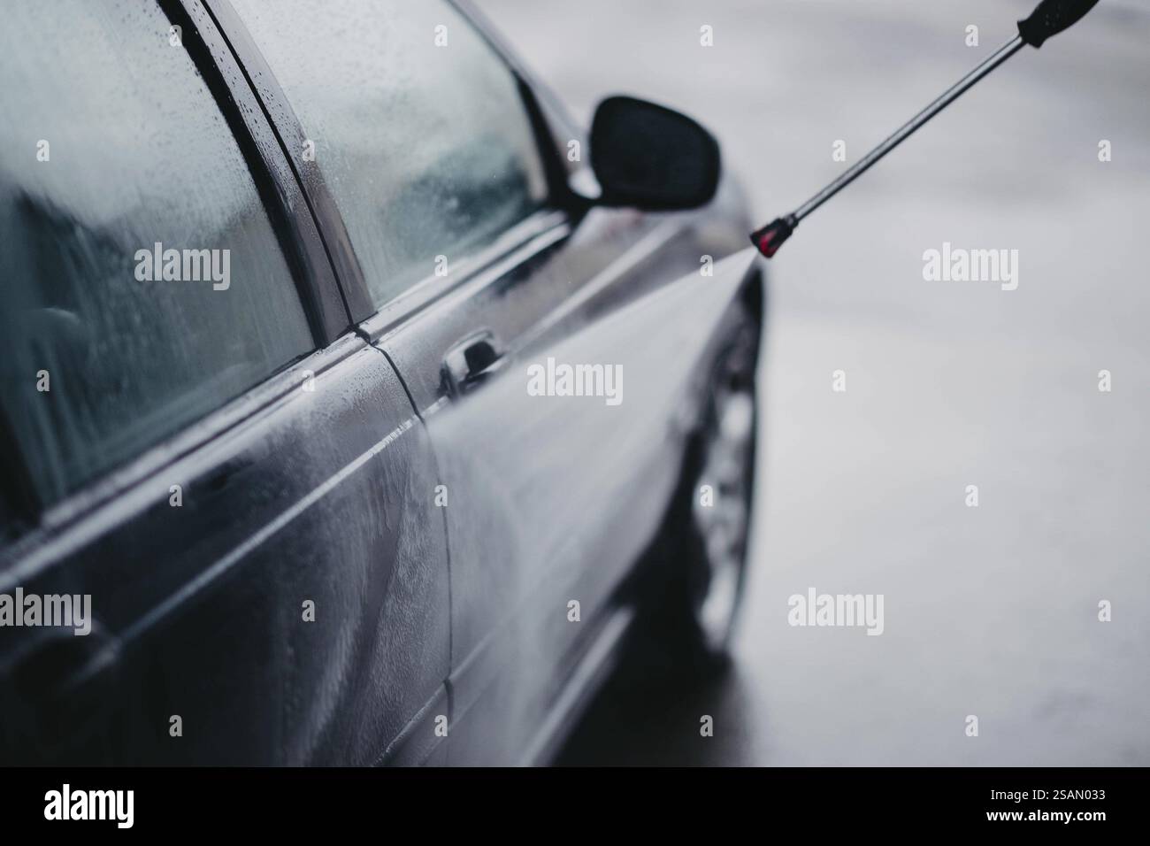 Water being sprayed on the side of a car Stock Photo - Alamy