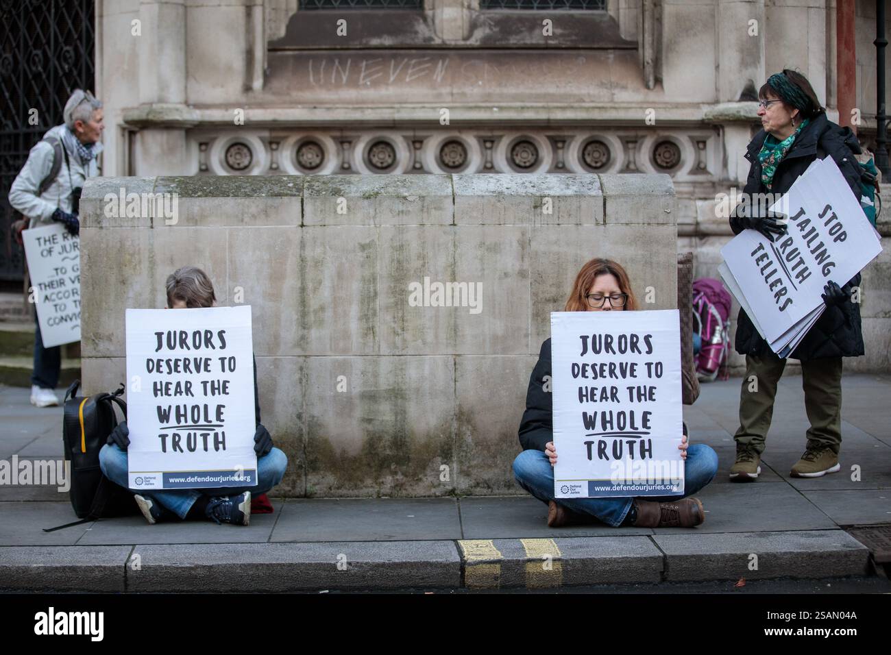 London, UK. 29th January, 2025. Supporters of Defend Our Juries are pictured holding signs ...