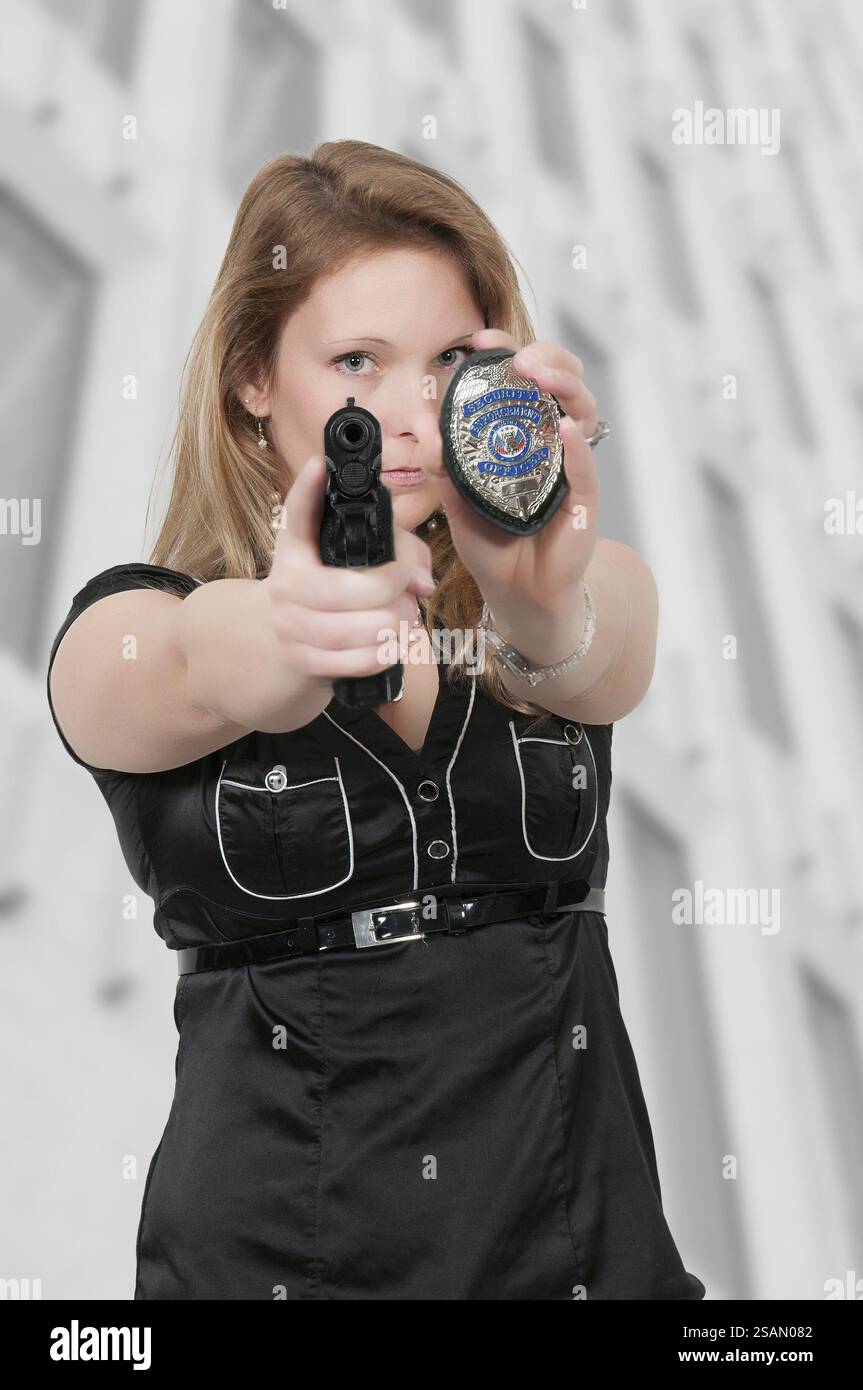 Beautiful police detective woman on the job with a gun Stock Photo - Alamy