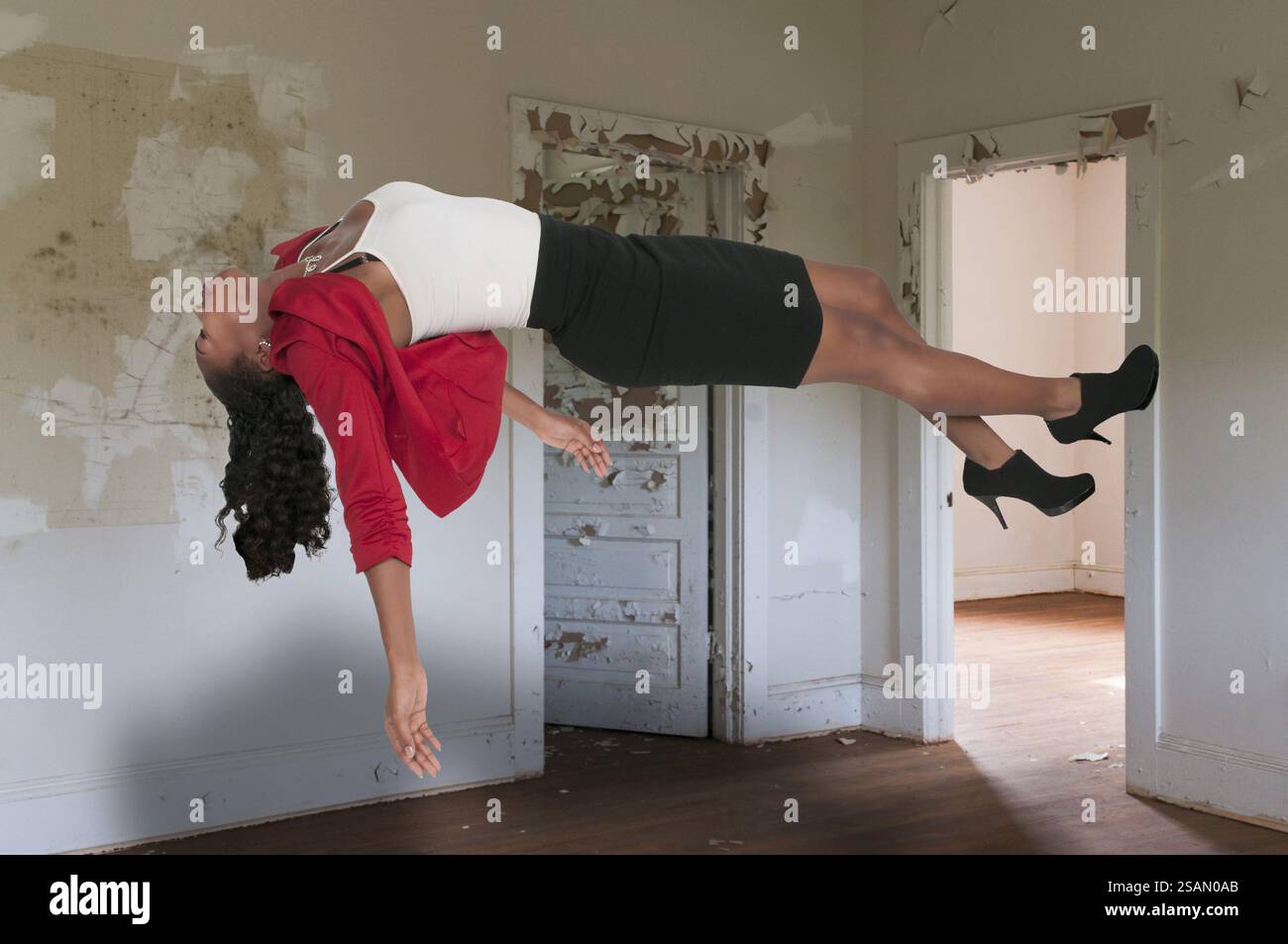 Beautiful young black woman floating in the air Stock Photo - Alamy
