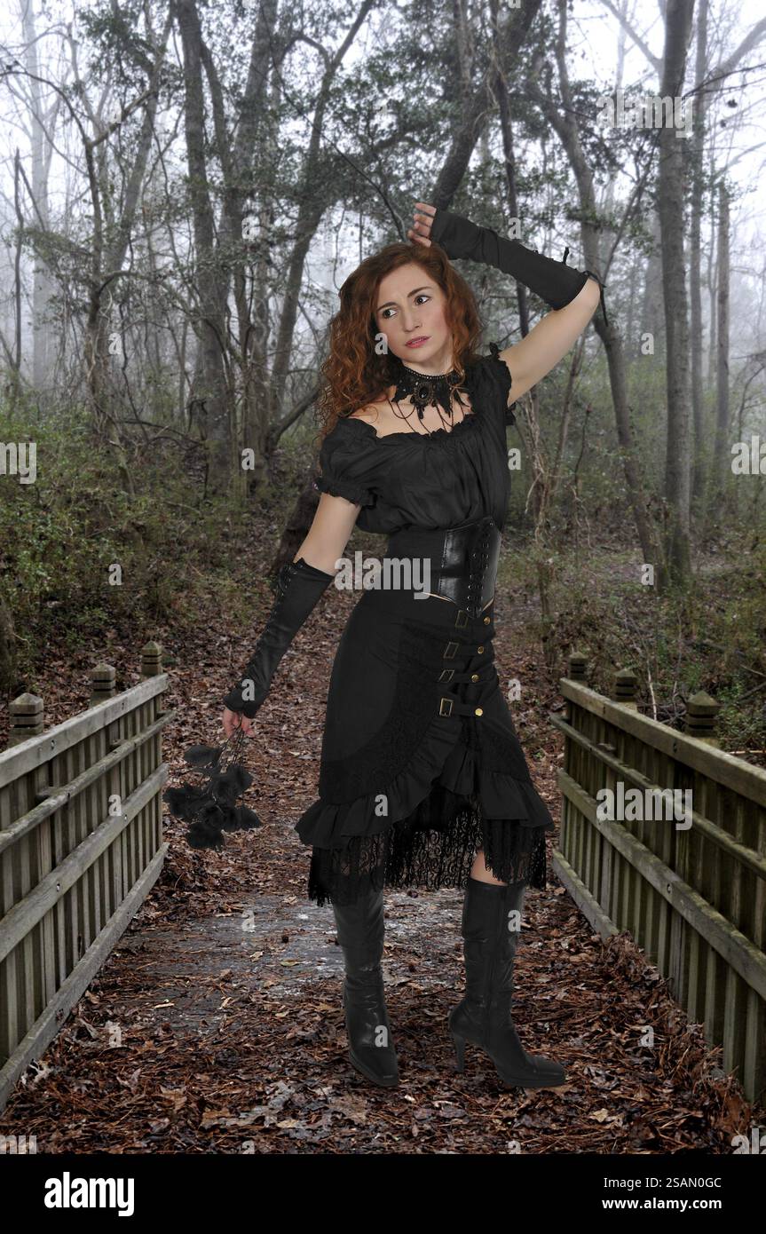 Sad gothic renaissance woman holding black flowers Stock Photo - Alamy