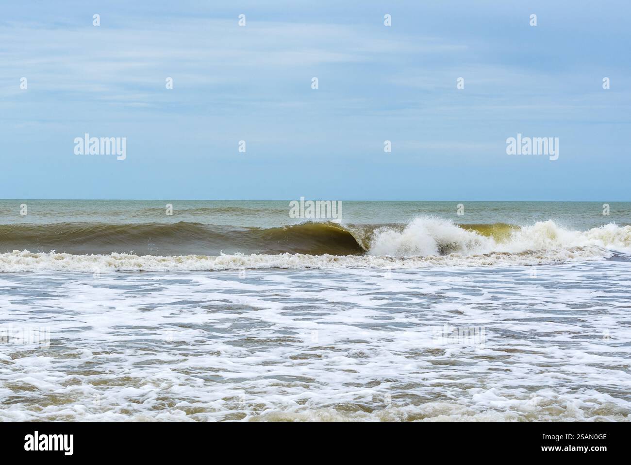 Waves roll sandy beach under hi-res stock photography and images - Alamy