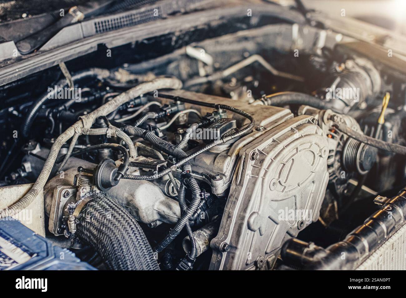 Detailed view of car engine components showing wires and mechanical ...