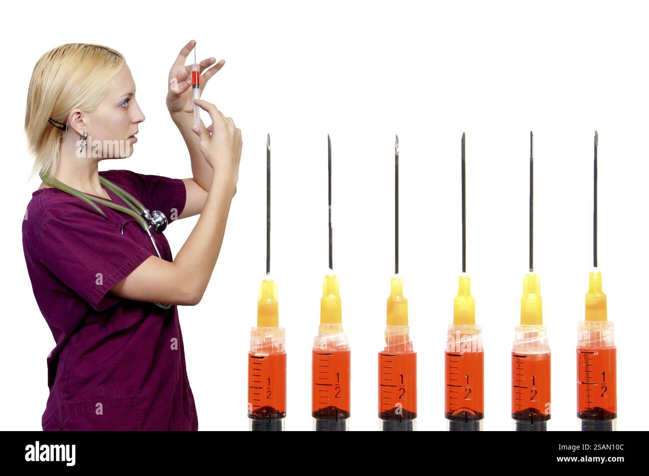 A beautiful blonde woman medical doctor preparing an injection in a ...