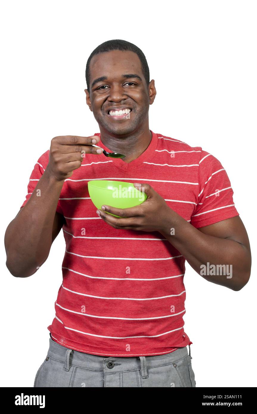Young black African American man eating food from a bowl Stock Photo ...