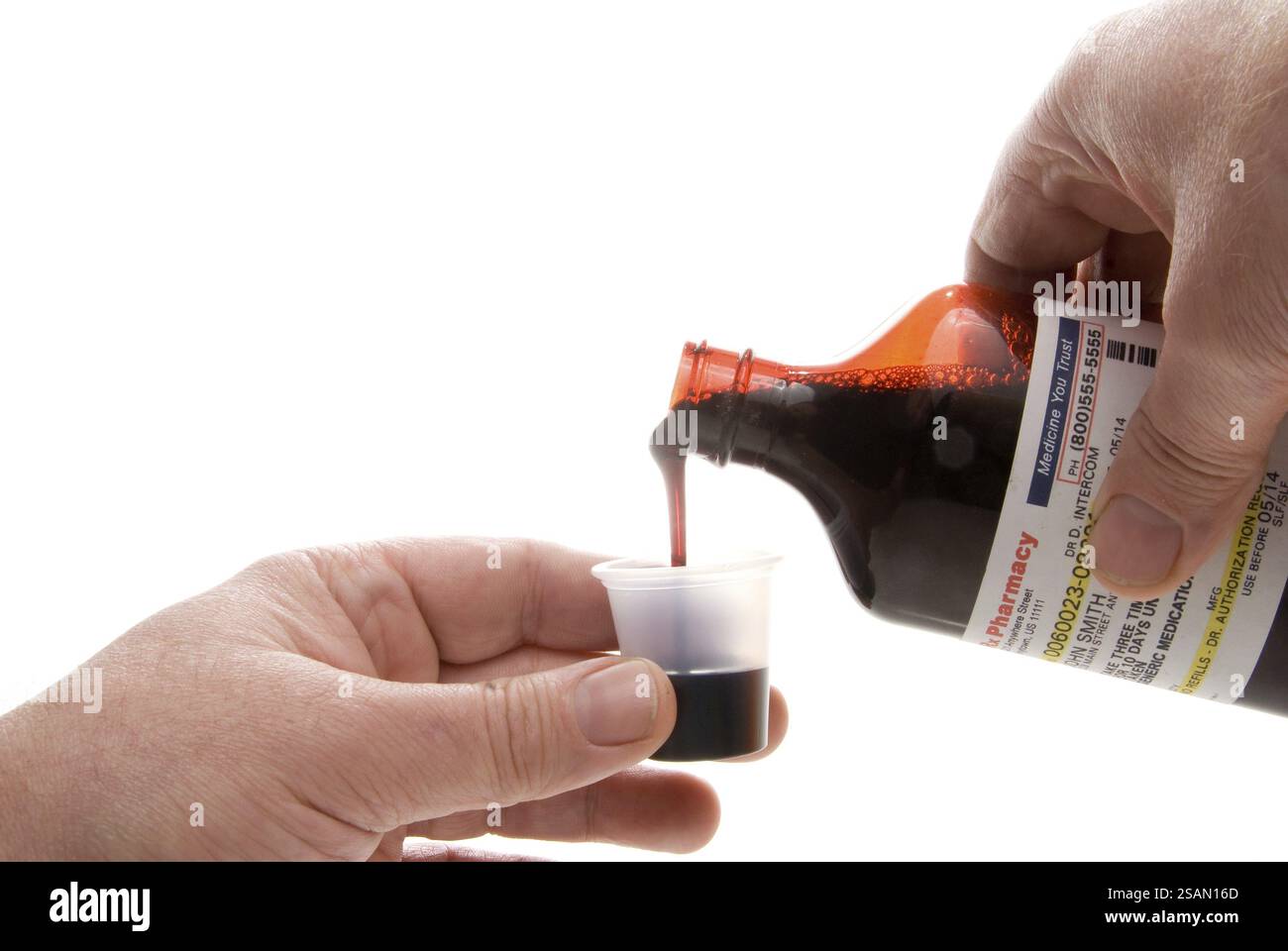 Liquid prescription cough medication in a cup Stock Photo - Alamy