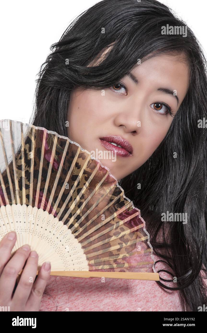 Beautiful Asian woman with an oriental fan Stock Photo - Alamy