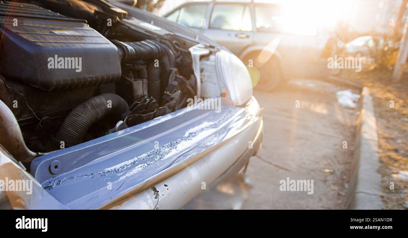 Car hood in sunlight showing lens flare with exposed engine Stock Photo ...