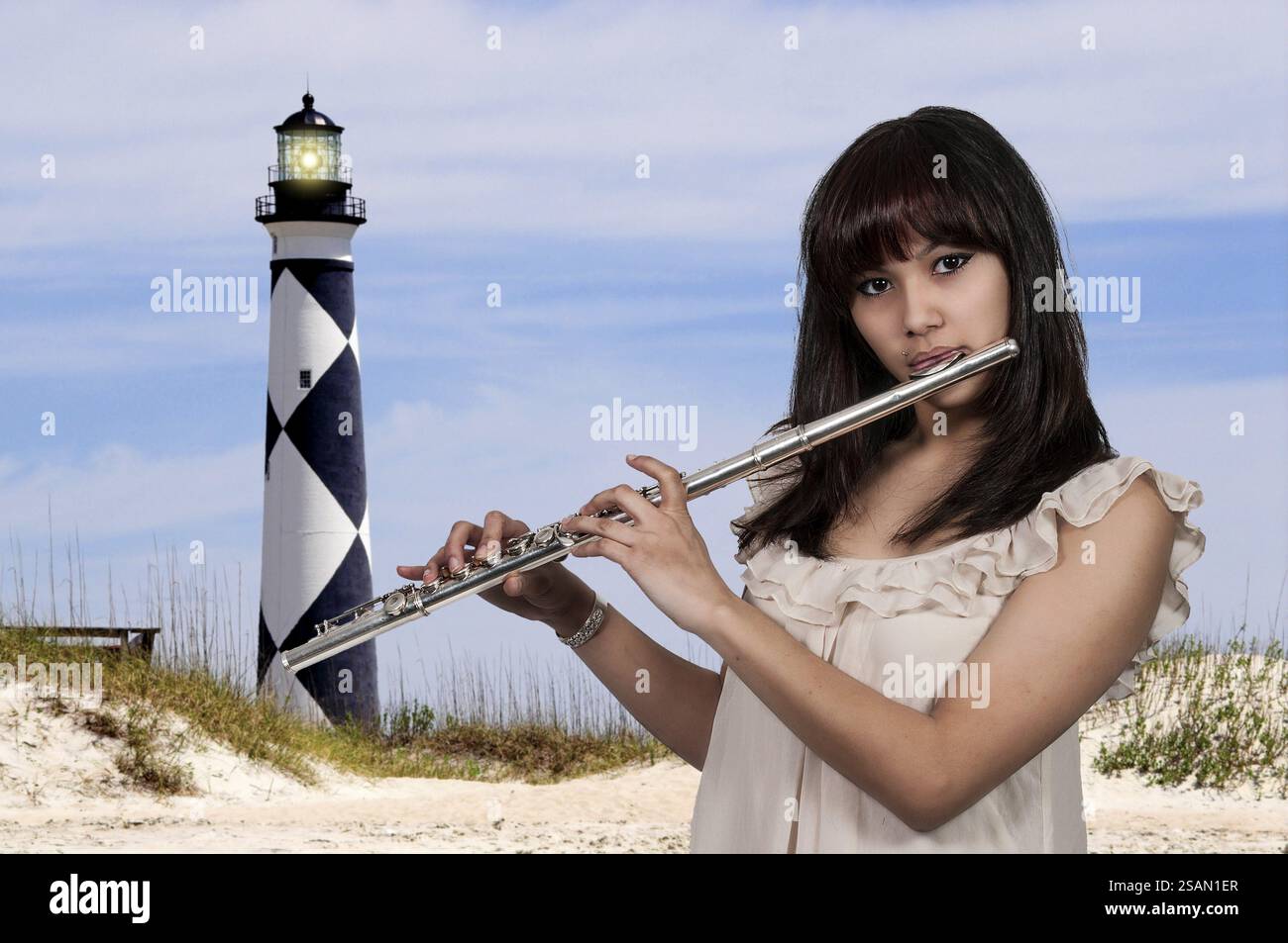 Beautiful young woman playing the musican instrument the flute Stock ...