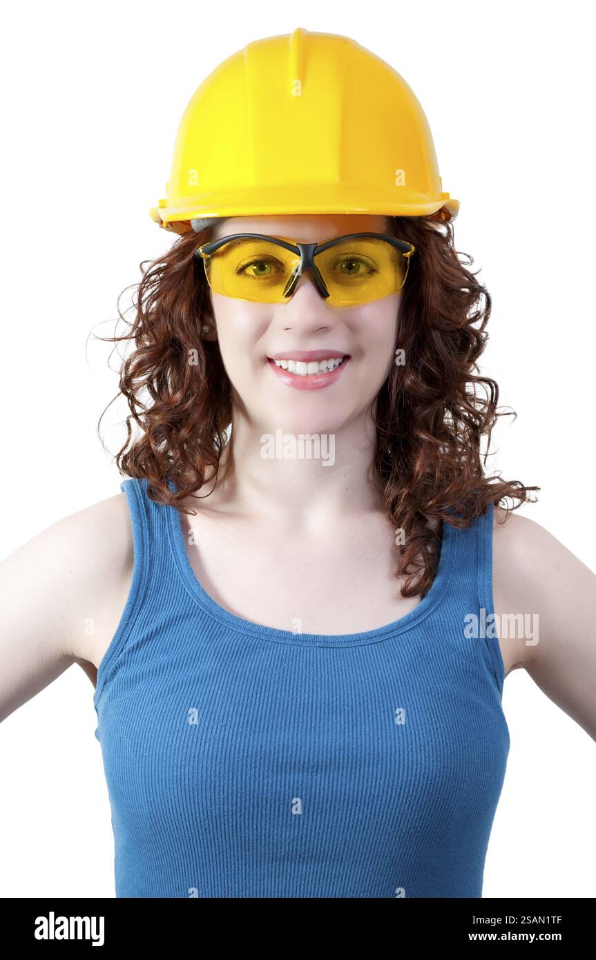 A Female Construction Worker wearing a hard hat and safety glasses ...