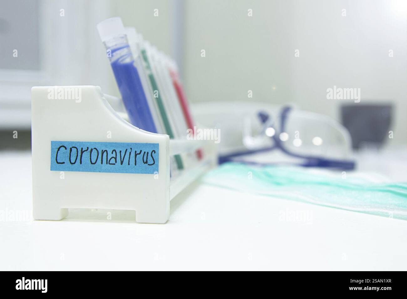 Test tube holder with colorful tubes labeled coronavirus in a lab ...