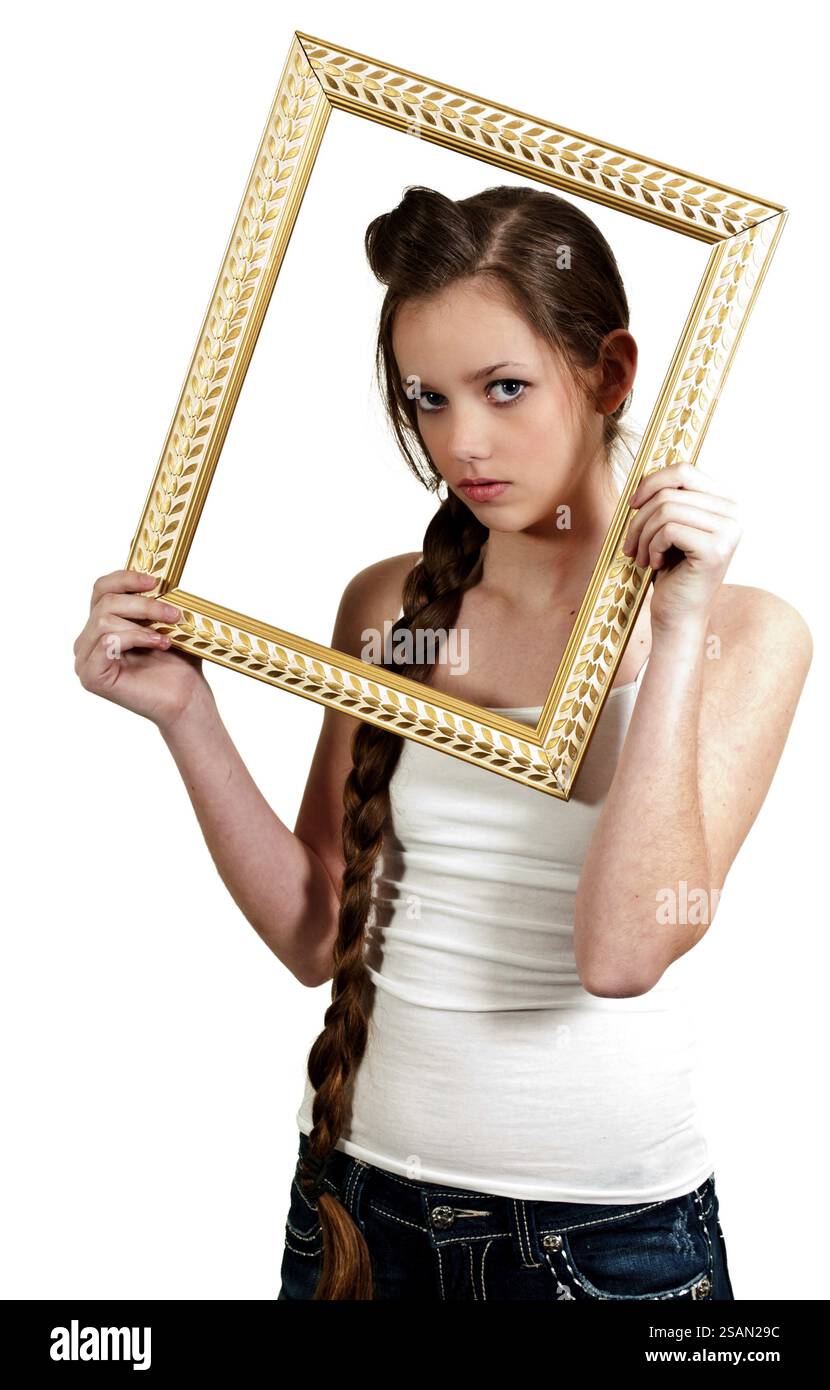Beautiful woman looking through an ornate picture frame Stock Photo - Alamy