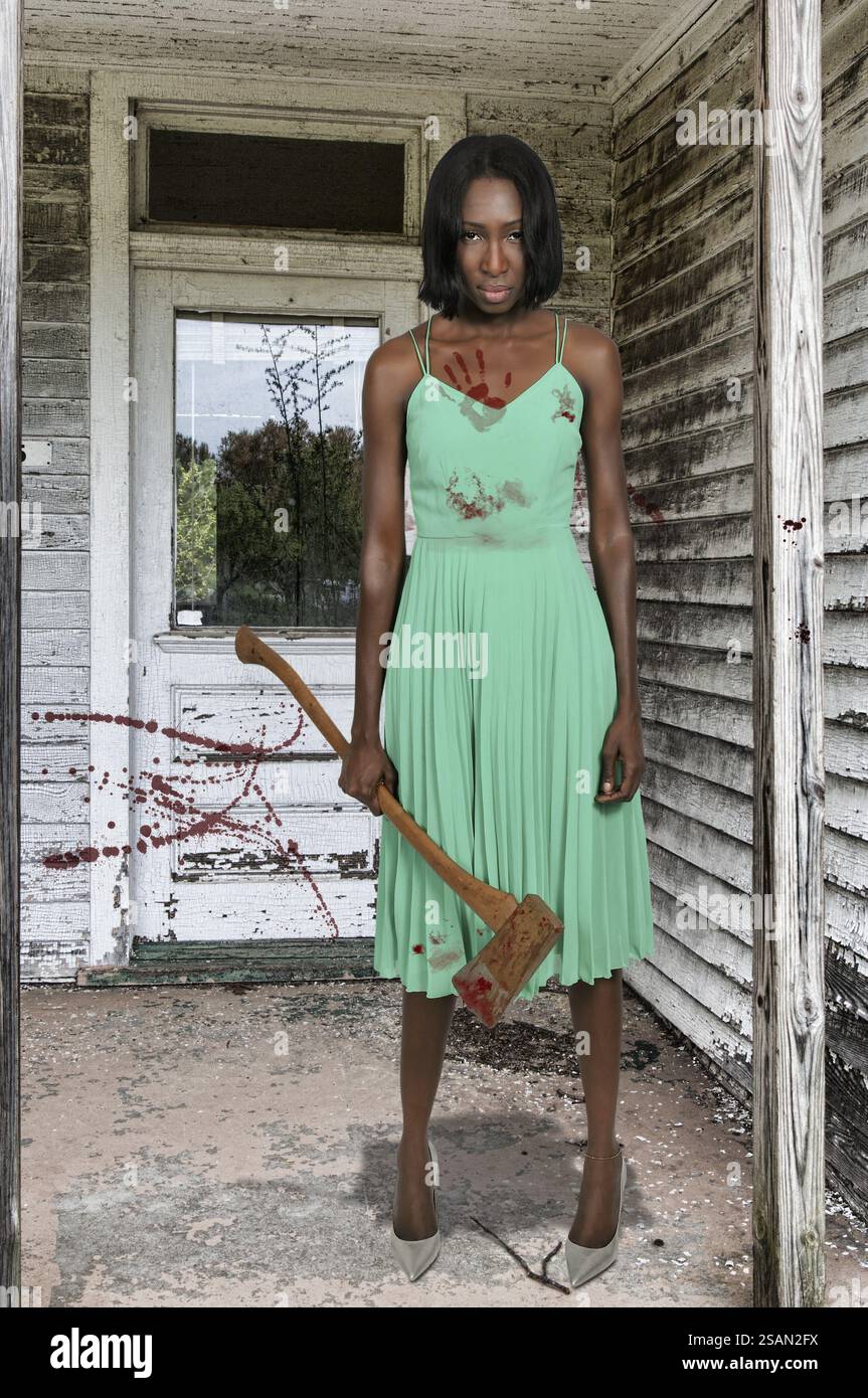 Beautiful possessed woman in a trance holding an axe Stock Photo - Alamy