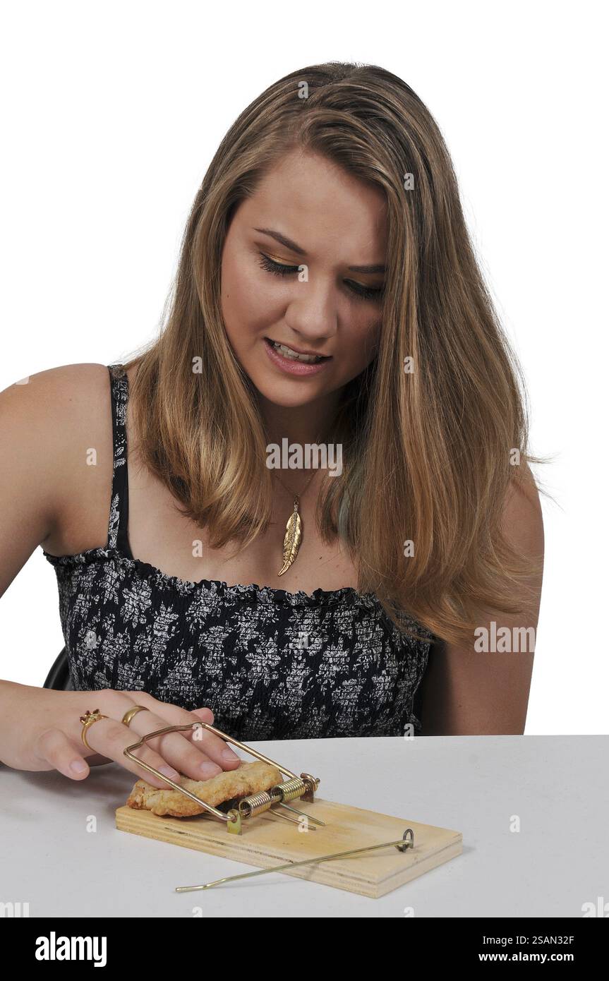 Beautiful woman using the mouse trap diet plan Stock Photo - Alamy