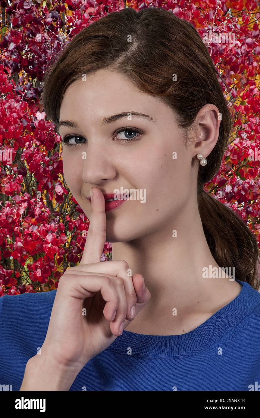 A woman saying be quiet by saying shhh Stock Photo - Alamy