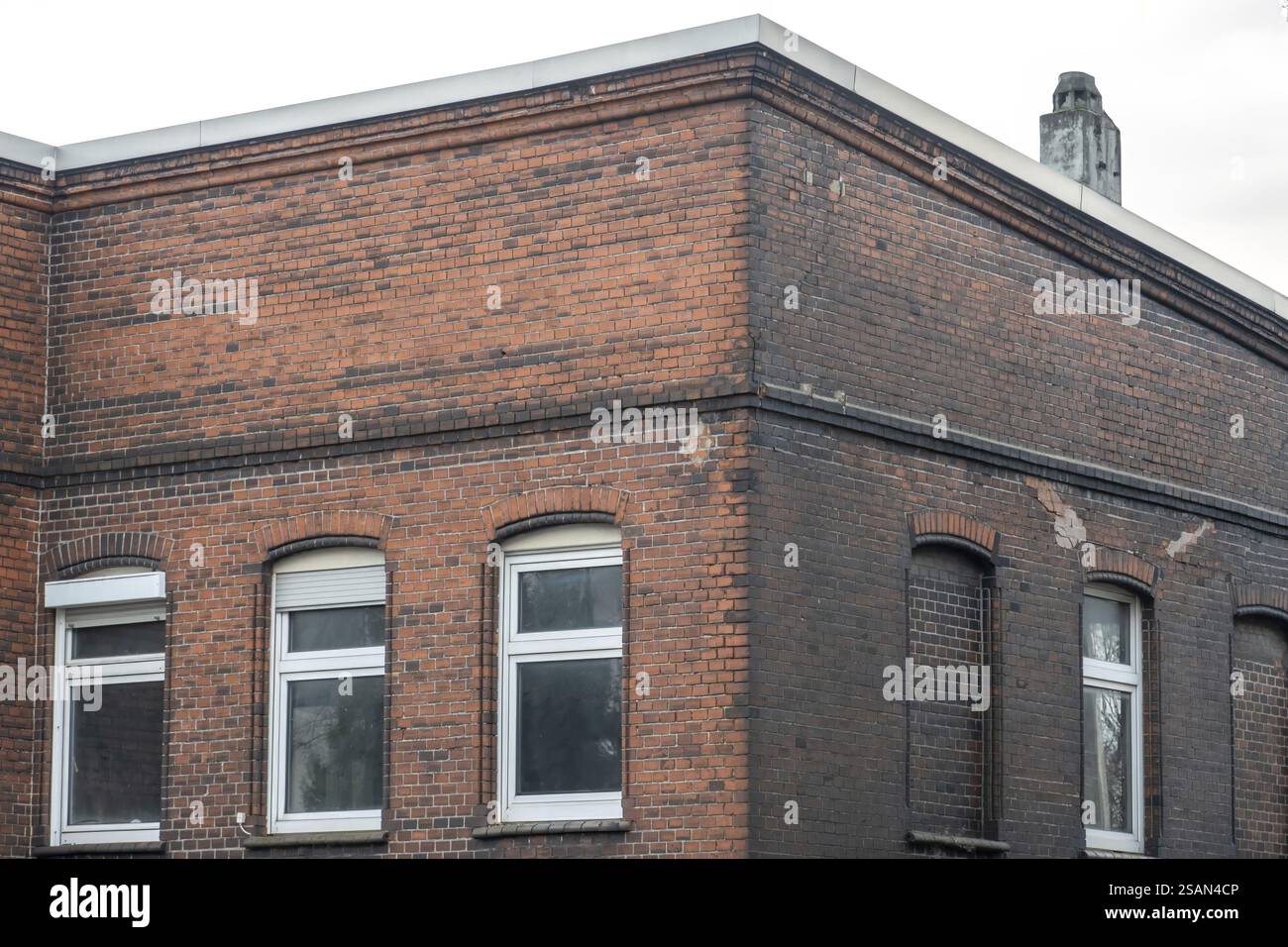 Brick facade of an old building showing weathering, discoloration, and ...
