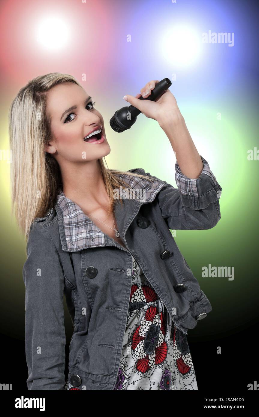 Beautiful woman singer performing at a concert Stock Photo - Alamy