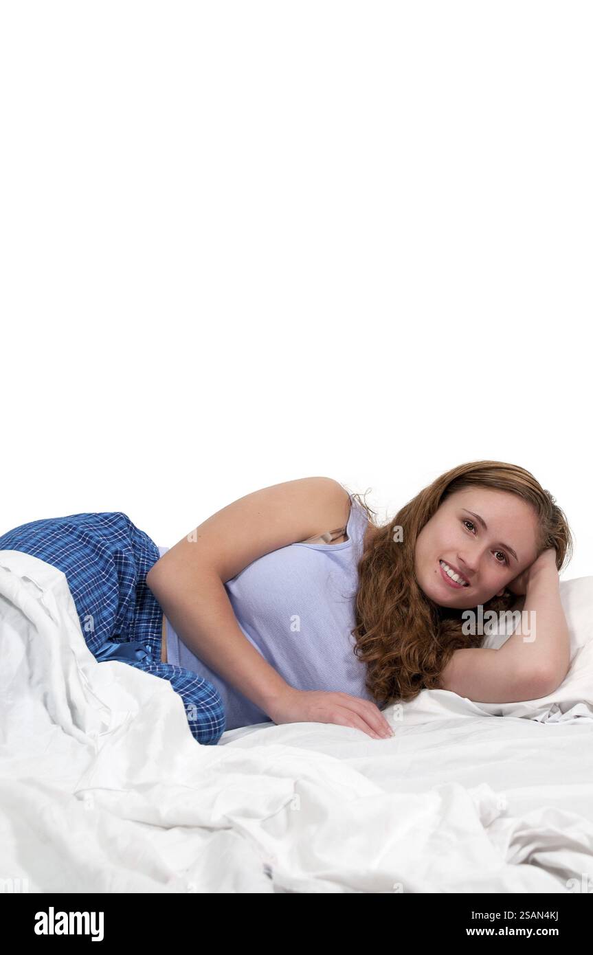 Beautiful young woman in bed at bedtime Stock Photo - Alamy