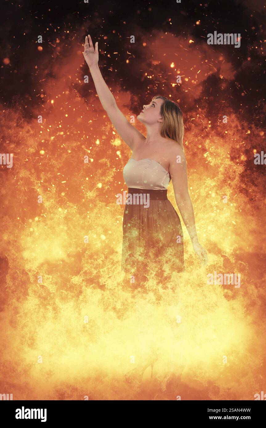 Beautiful woman standing in the midst of a fire Stock Photo - Alamy