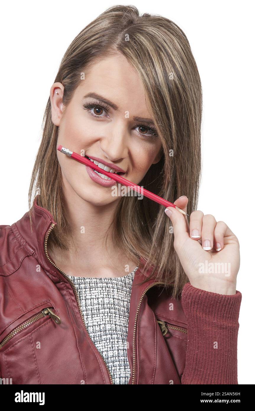 Beautiful woman college student chewing on a pencil Stock Photo - Alamy