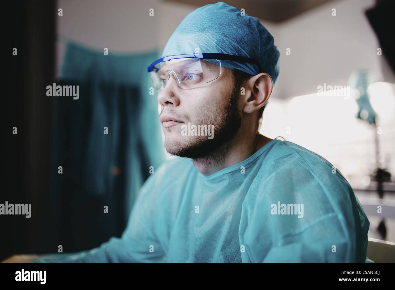 A person in surgical attire, appearing focused and concentrated Stock ...