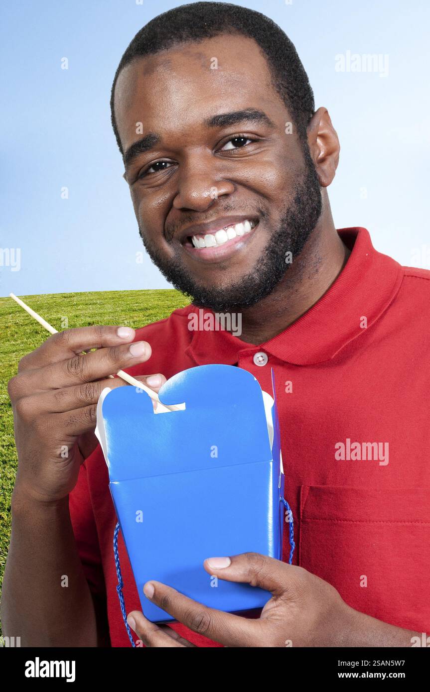 Black African American man eating Chinese or Japanese Asian food Stock ...