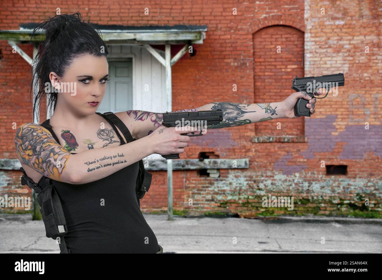 Beautiful young woman shooting things with pistols Stock Photo - Alamy