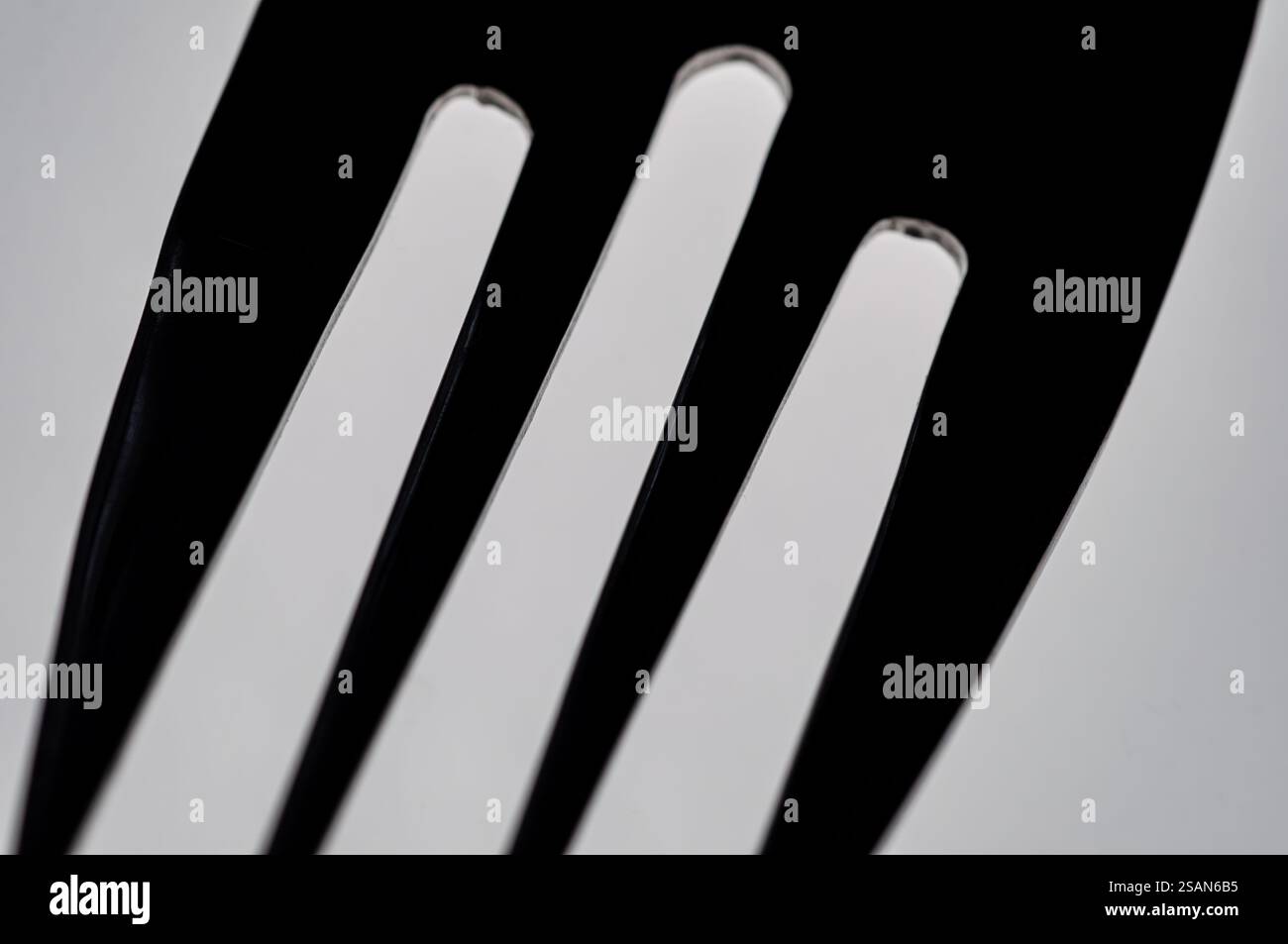 Close-up view of a fork's tines. The image highlights the contrasting ...