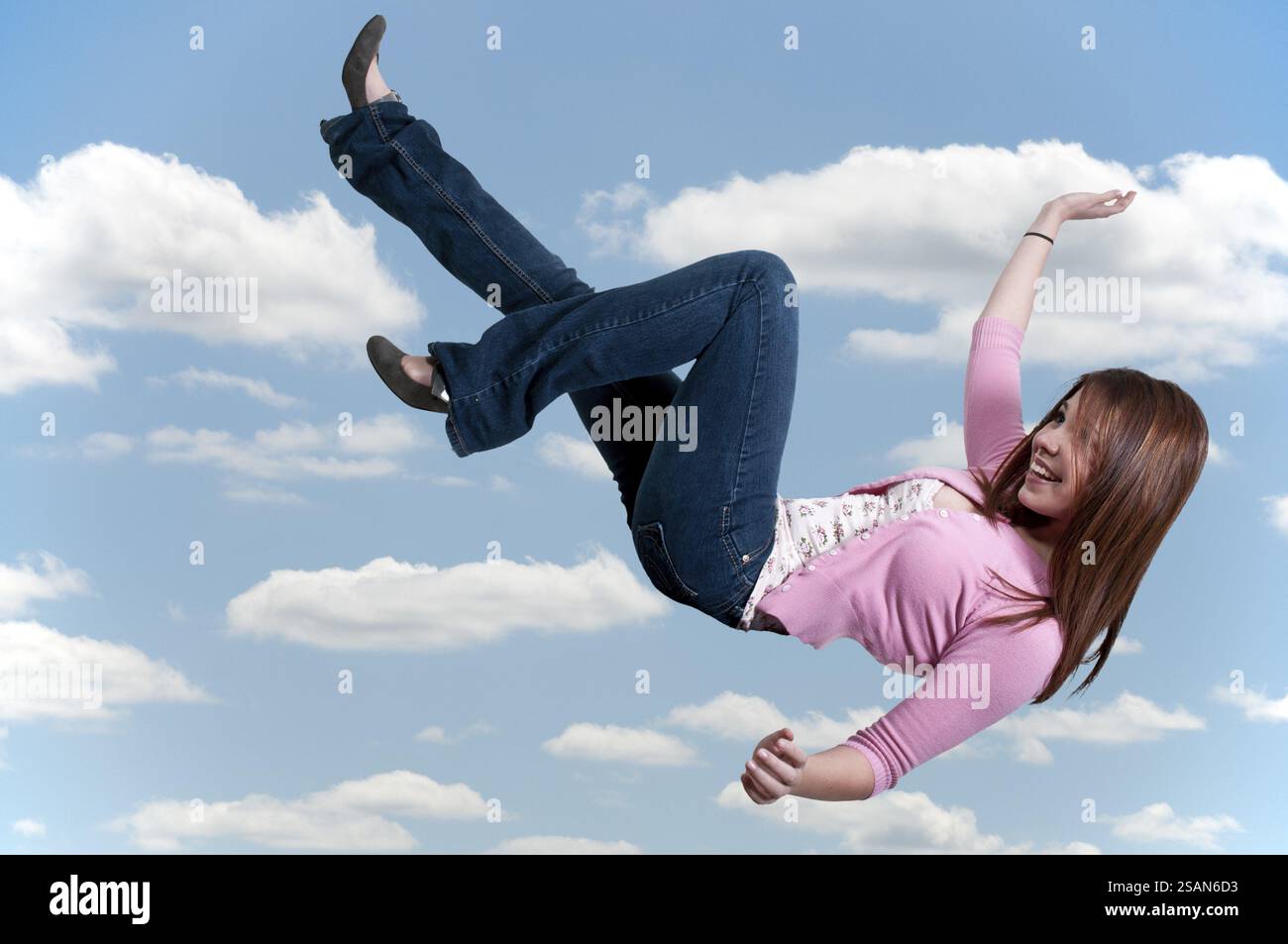 A beautiful young woman falling through the sky Stock Photo - Alamy