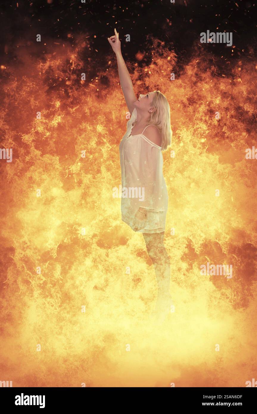 Beautiful woman standing in the midst of a fire Stock Photo - Alamy