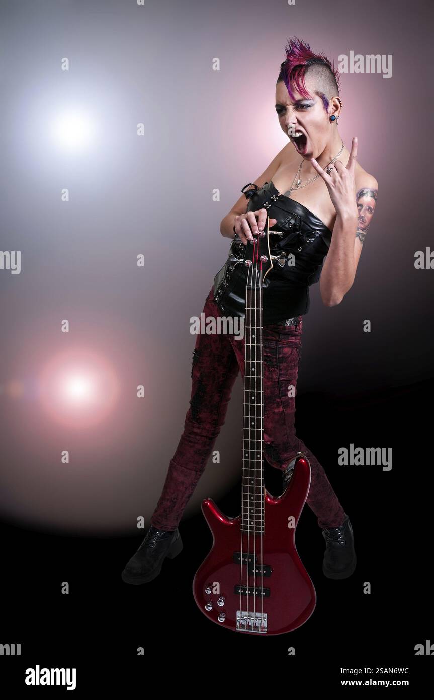 Beautiful woman punk rocker with an electric bass guitar Stock Photo ...