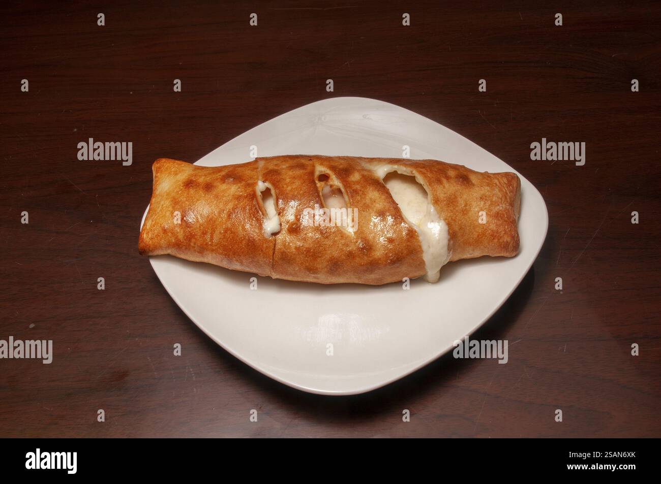 Delicious Italian dish best known as stromboli Stock Photo - Alamy