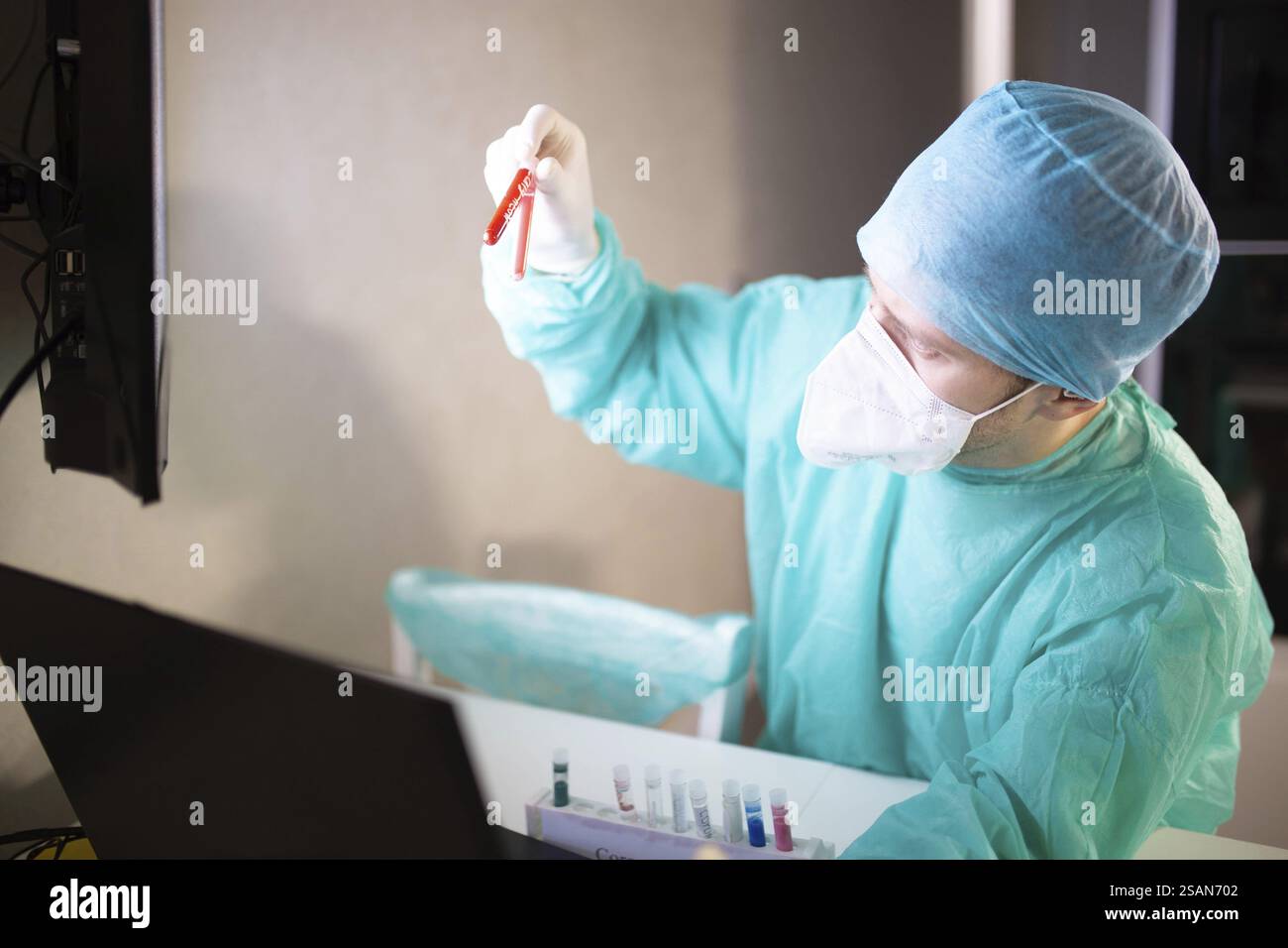 Medical professional carefully inspecting a red test tube sample Stock ...