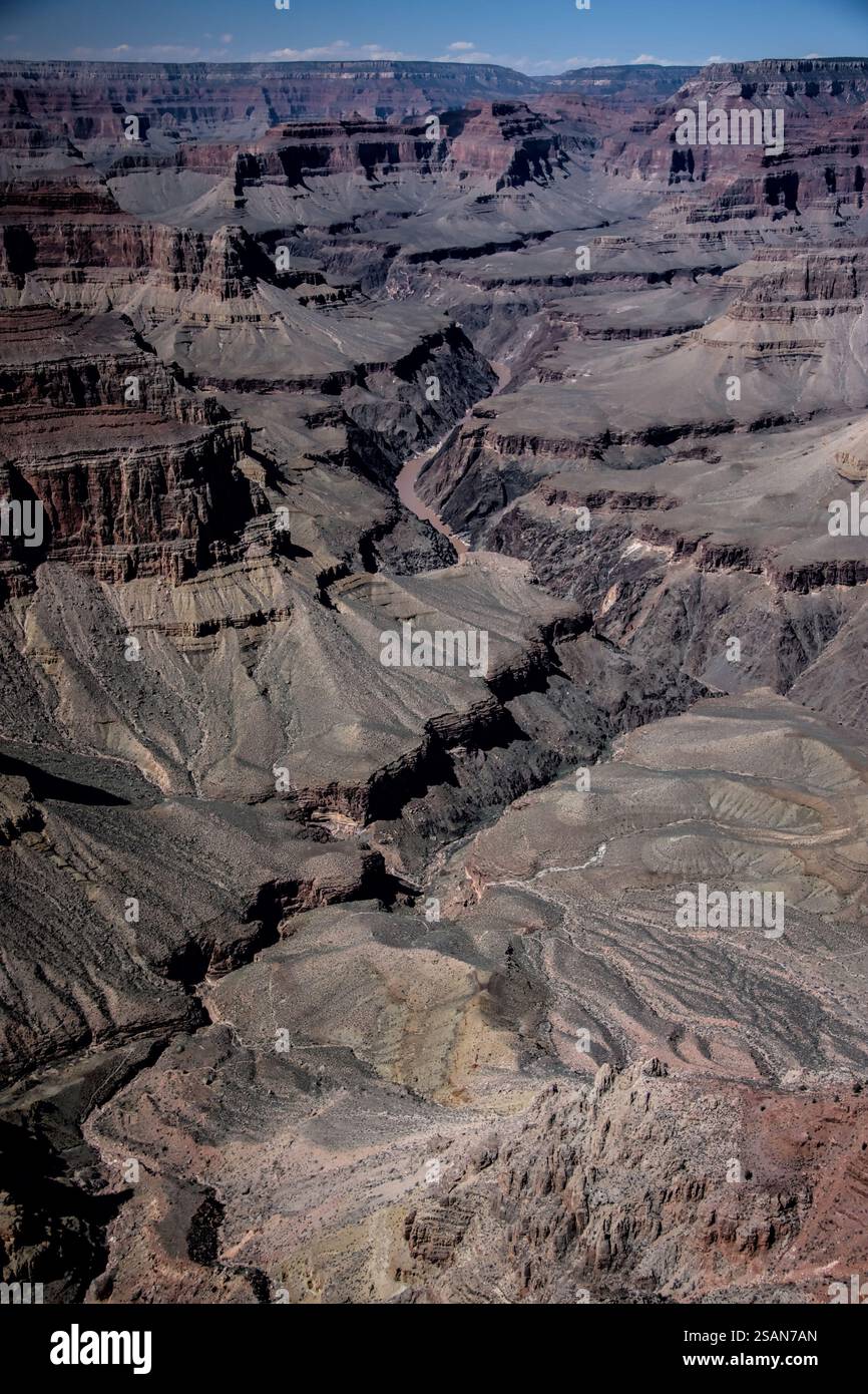 A canyon with a river running through it. The canyon is very deep and ...