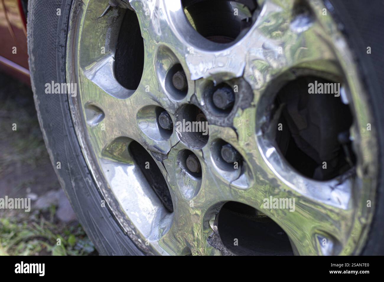 Side view of a damaged chrome rim with rust visible on bolts Stock ...