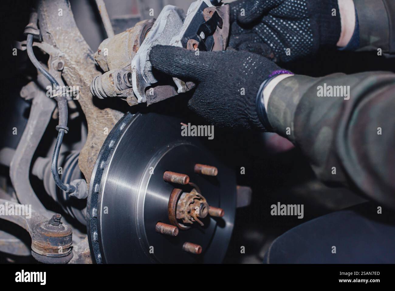 Mechanic working on a car brake system with gloves Stock Photo - Alamy