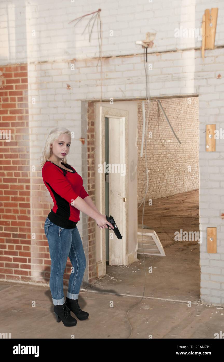 Beautiful woman with a loaded handgun pistol Stock Photo - Alamy